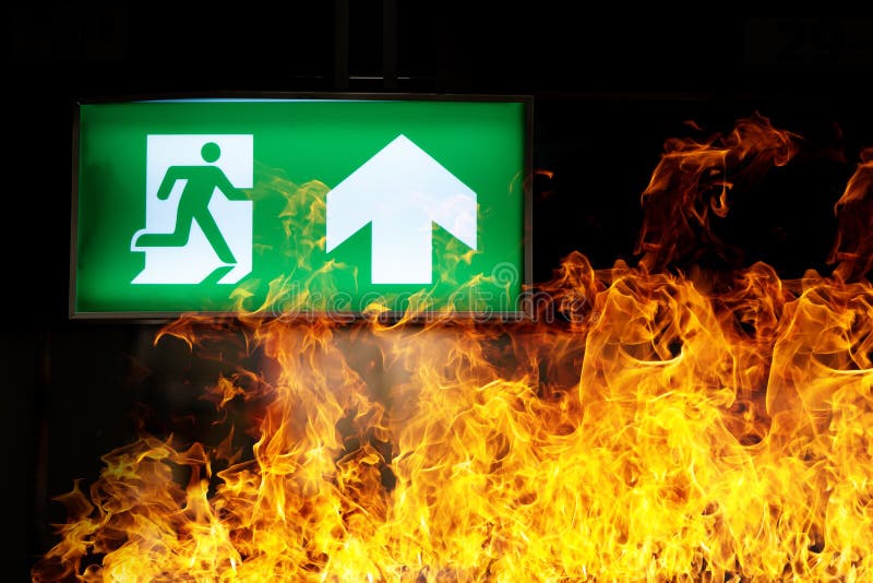 Green Fire Escape Sign Hang on the Ceiling in the Warehouse. the ...