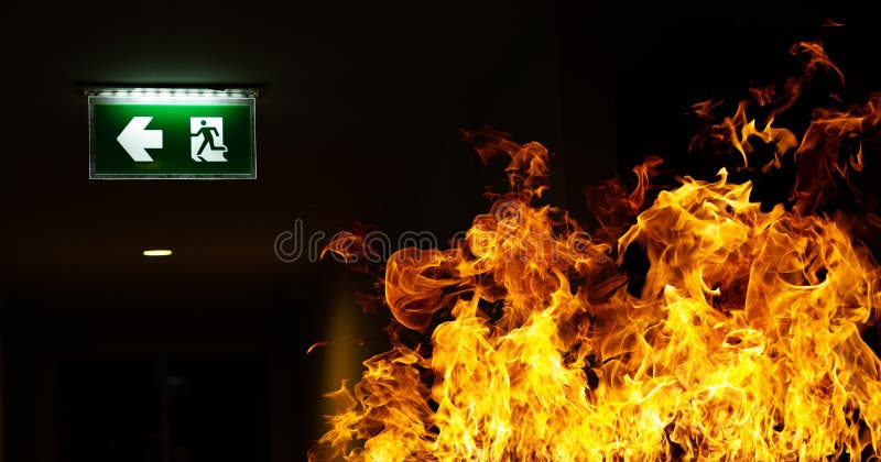 Green Fire Escape Sign Hang on the Ceiling in the Warehouse. the ...