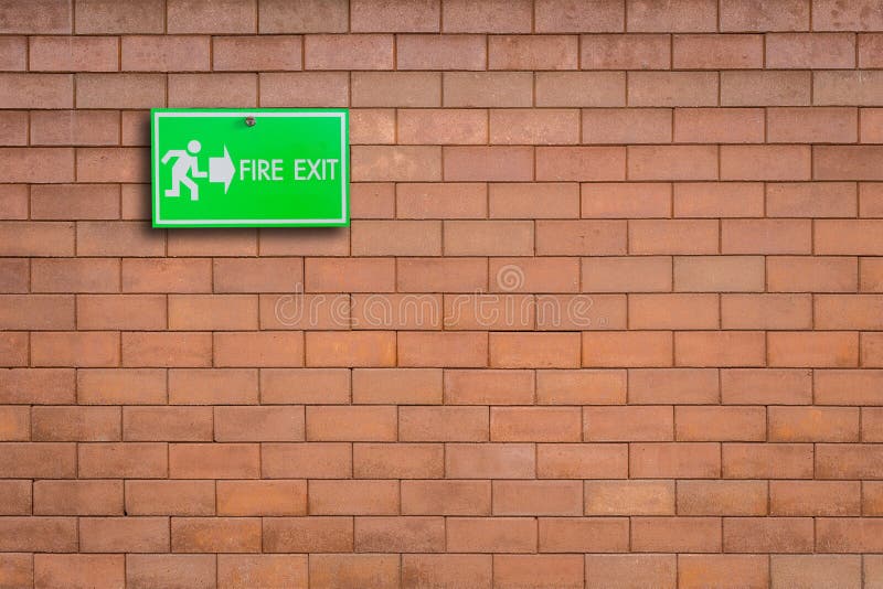 Green Fire Exit Sign on Stone Wall Stock Image - Image of safety ...