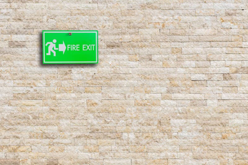 Green Fire Exit Sign on Stone Wall Stock Image - Image of light ...
