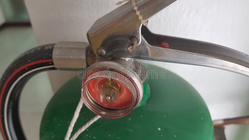 Green fire extinguisher stock image. Image of closeup - 153205197