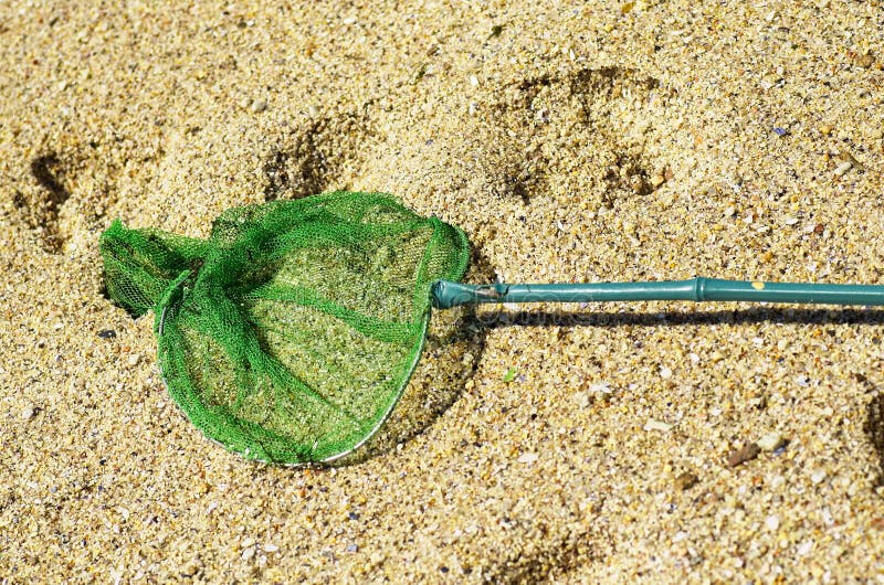 Green Fishing Net on the Sand Stock Image - Image of stick, calm: 192228423