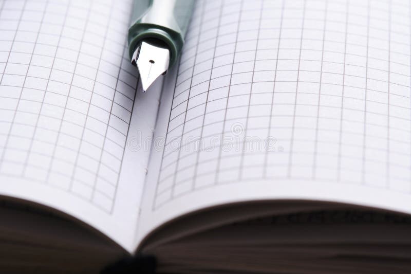 Green Fountain Pen Lies on White Sheets Checkered Notebook. Stock Photo ...
