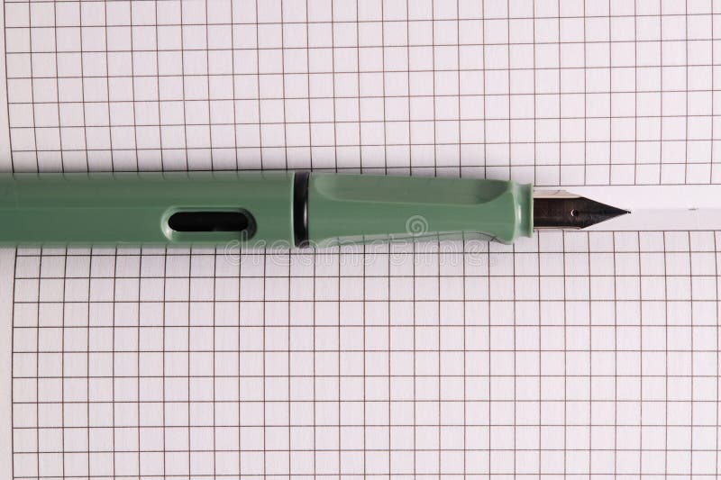 Green Fountain Pen Lies on White Sheets Checkered Notebook. Stock Photo ...
