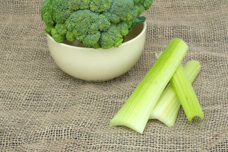 Green Fresh Vegetables. Whole Broccoli in a Bowl with Celery on the ...
