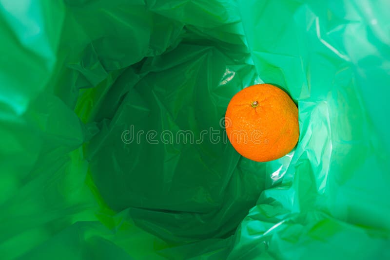 A Green Garbage Bag in the Trash. There is an Orange Inside Stock Image ...