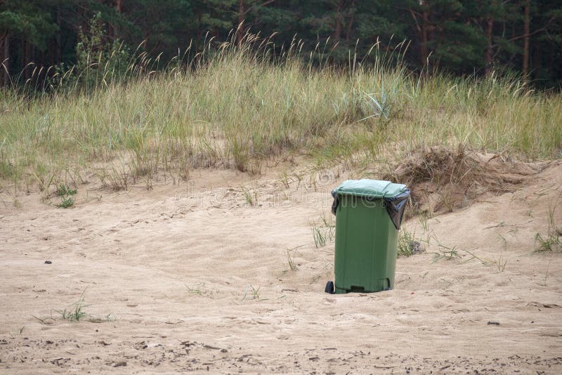 .green Garbage Can in the Sand of the Sea Beach Stock Image - Image of ...