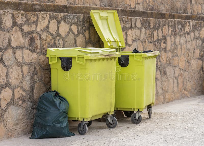 Green Garbage Containers Near the Wall Stock Photo - Image of ragged ...