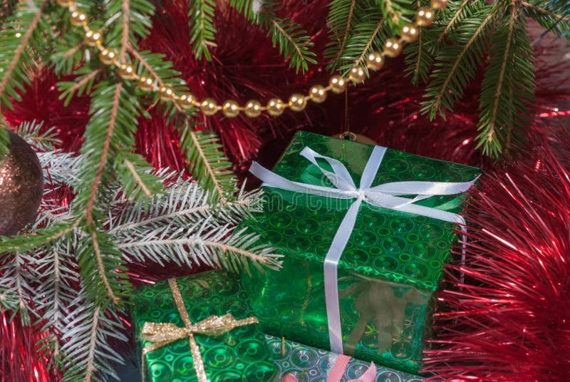 Green Gift Box Under Christmas Tree Branches Stock Photo - Image of ...