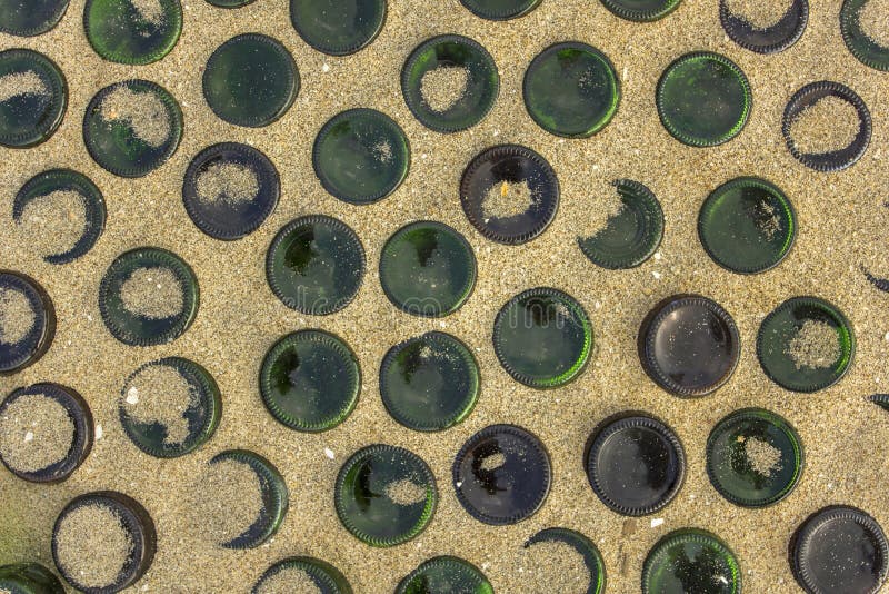 Green Glass Bottles Protrude from the Sand a Round Bottom Up. Rough ...