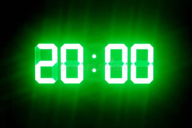 Green Glowing Digital Clocks in the Dark Show 20:00 Time Stock Image ...
