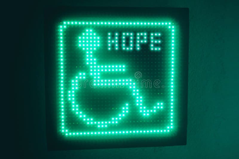 Green Glowing Symbol of the Disabled Hanging on the Wall Stock Image ...