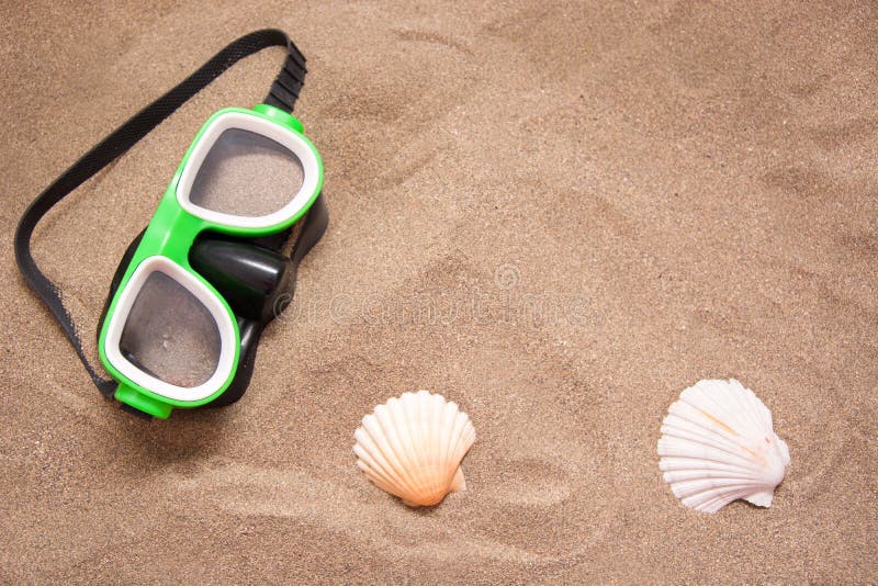 Green Goggles and Snorkel and Shell Tube on Sand Stock Photo - Image of ...