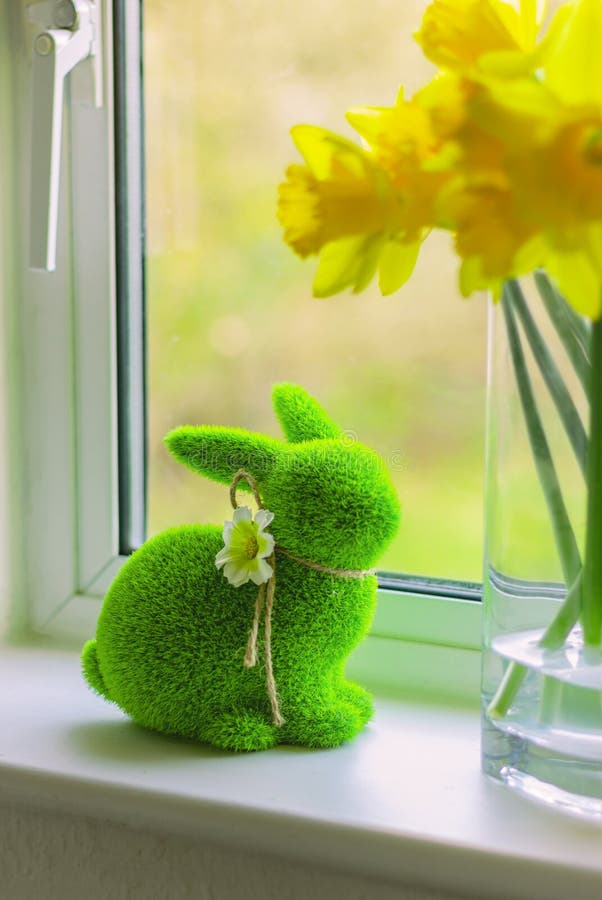 Green Grass Easter Rabbit and Yellow Flowers in Vase on Windowsill ...