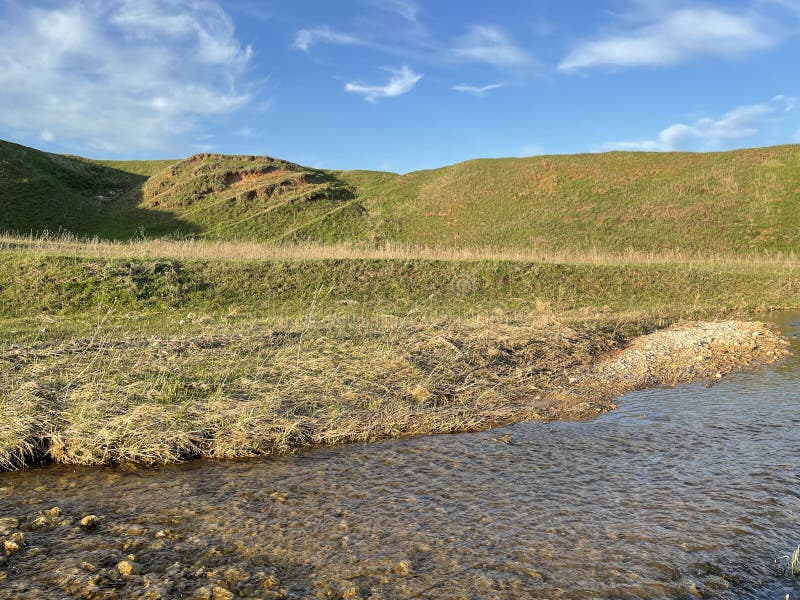 Green Grass on a Small Hill with a Clear Stream Stock Photo - Image of ...