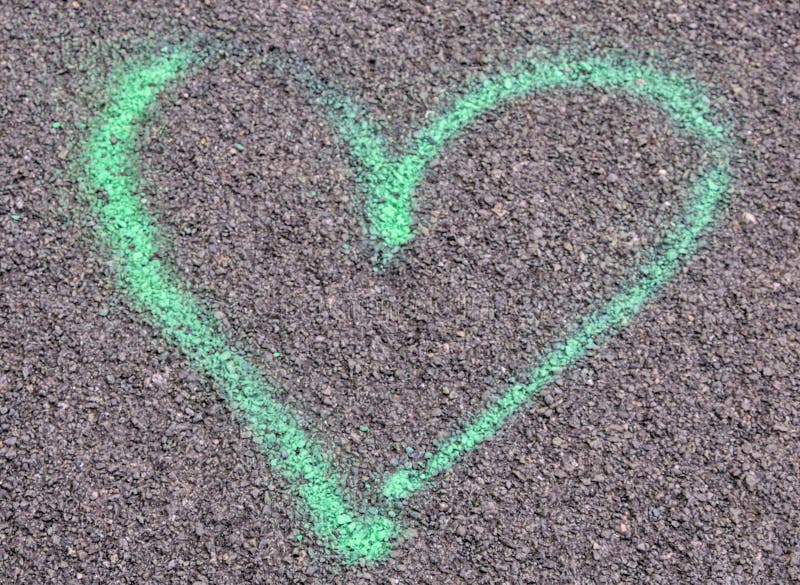 Green heart on asphalt stock image. Image of painting - 373687223