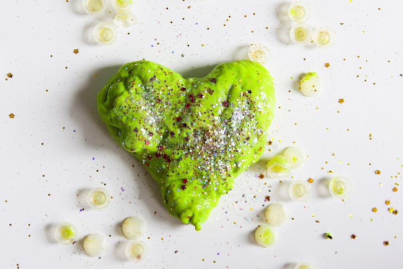 Green Heart with Shiny Glitters Made from Slime Stock Image - Image of ...