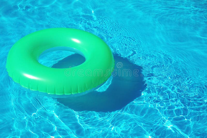Green Inflatable Ring Floating in Swimming Pool on Sunny Day Stock ...
