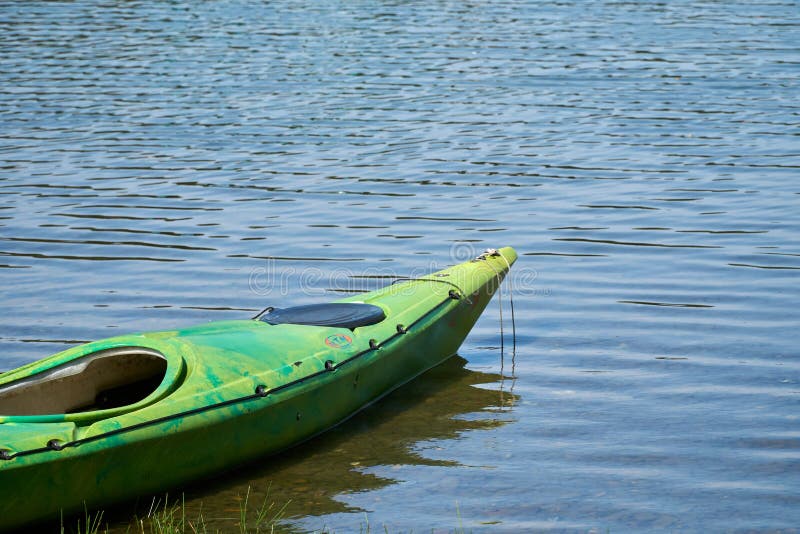 Green kayak at the lake stock photo. Image of activity - 199039950
