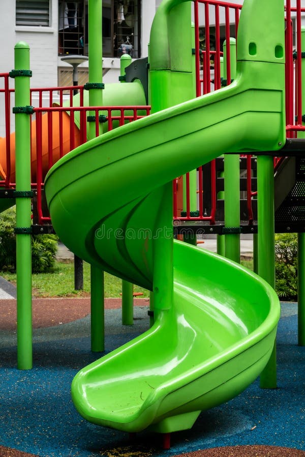 Green kids curve slide stock image. Image of outdoor - 230641951