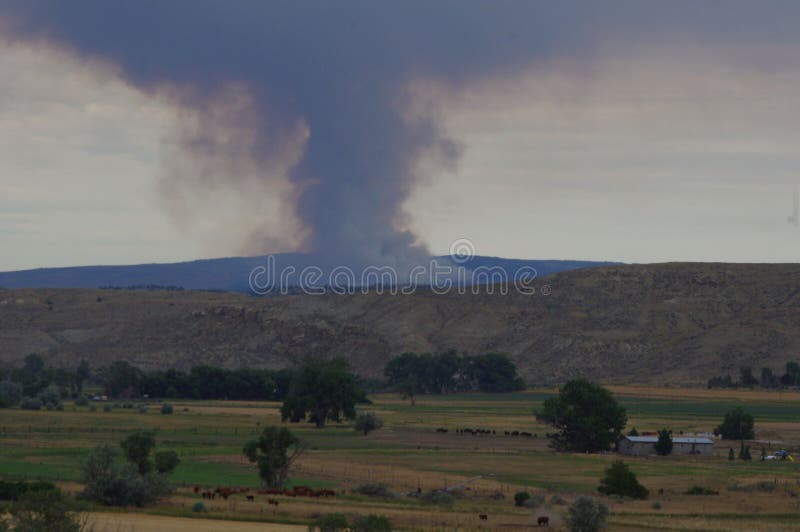 Green Landscape with Mountains and Wildfire Smoke Behind Them Stock ...