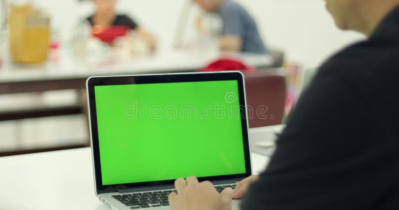Green Laptop Computer Screen Set in Front of Workgroup Stock Footage ...