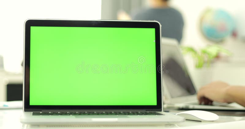 Green Laptop Computer Screen Set in Front of Workgroup Stock Video ...