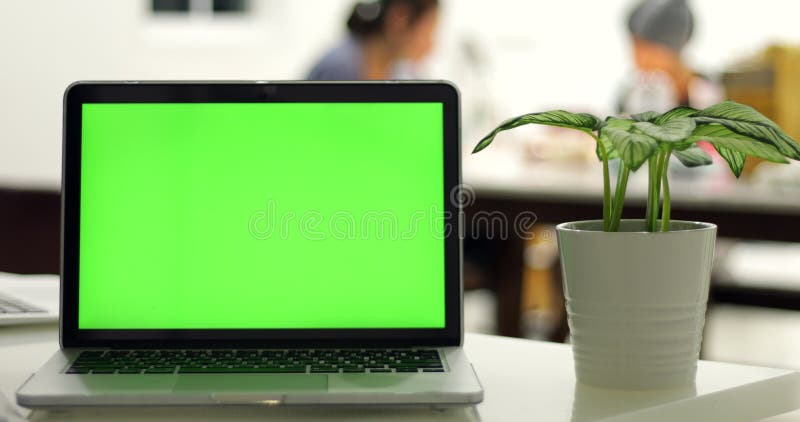 Green Laptop Computer Screen Set in Front of Workgroup Stock Video ...