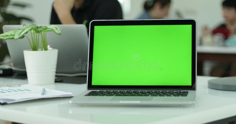 Green Laptop Computer Screen Set in Front of Workgroup Stock Footage ...