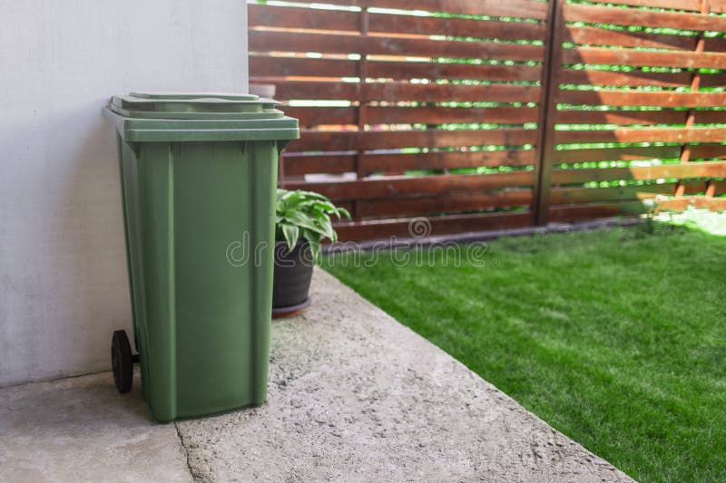 Green Large Plastic Bin for Trash on Backyard Stock Photo - Image of ...
