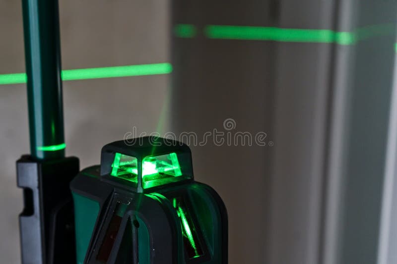 Green Laser Level Projecting Precise Alignment Lines on a Wall Stock ...
