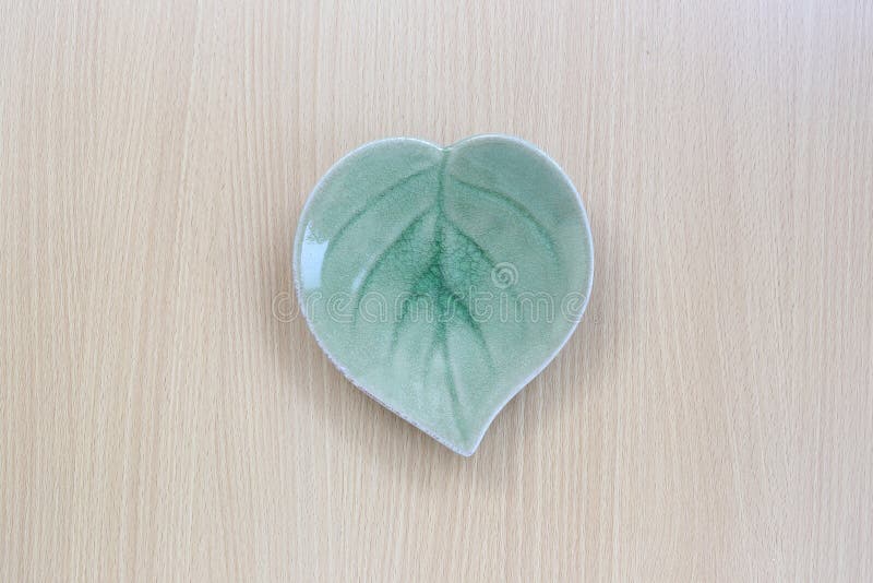 Green Leaf Shape Dish in Top View on Wood Background. Stock Image ...