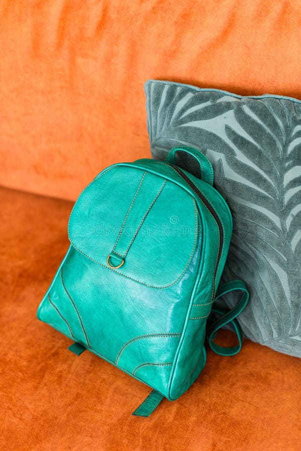 A Green Leather Modern Backpack on a Orange Sofa Stock Image - Image of ...