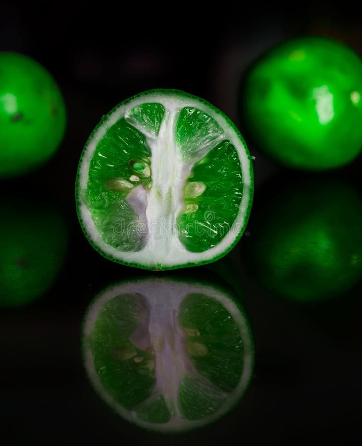 A Cut Lemon in Front of Two Lemons Stock Photo - Image of vegetables ...