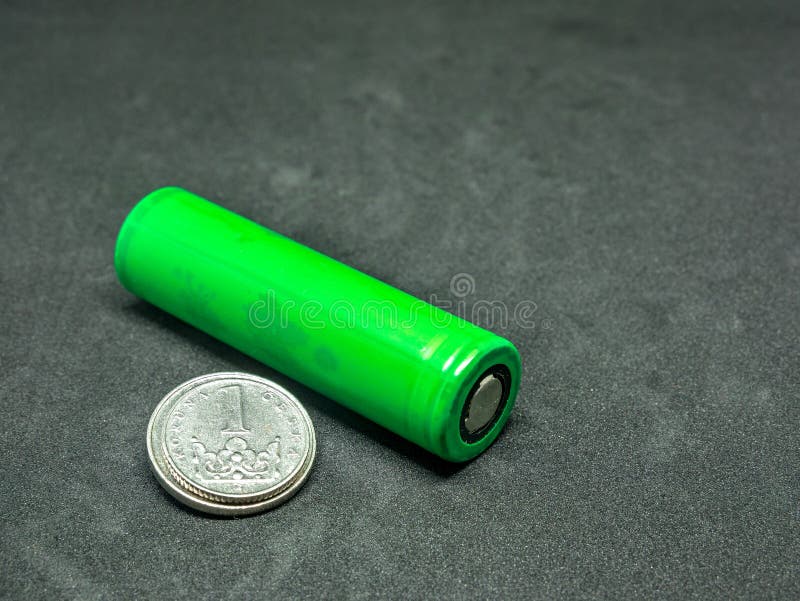 Green Li-ion Battery and Small Coins - Selective Focus Stock Image ...