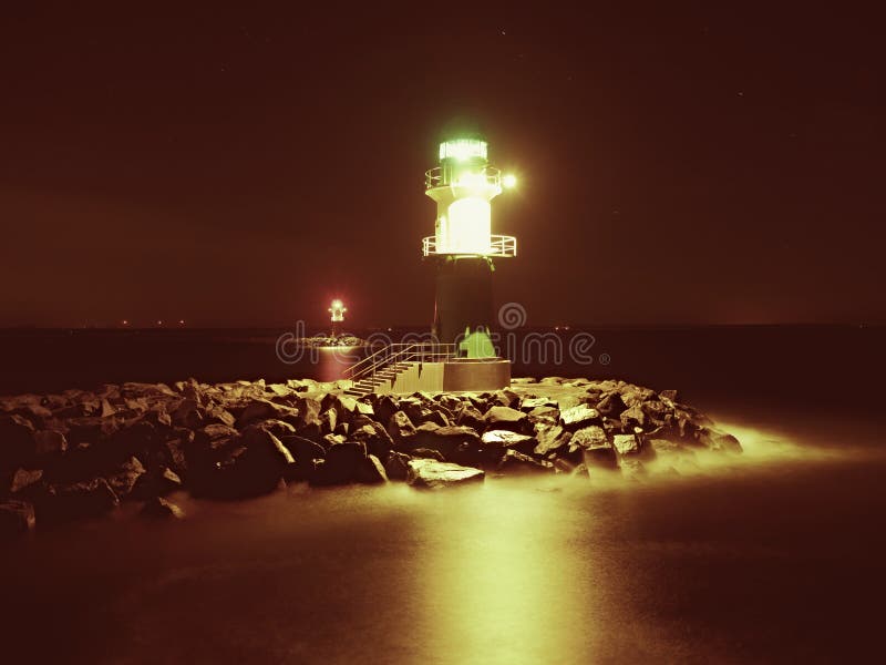 Green Lighthouse Shinning at the End of Stony Pier in Dark Night Stock ...