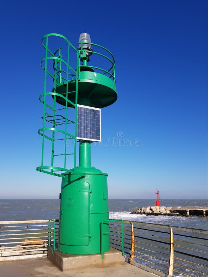 Green Lighthouse with Solar Panels on the Background of the Blue Sky ...