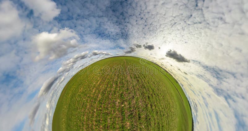 Green Little Planet Rotates in Beautiful Blue Sky with Evening Clouds ...