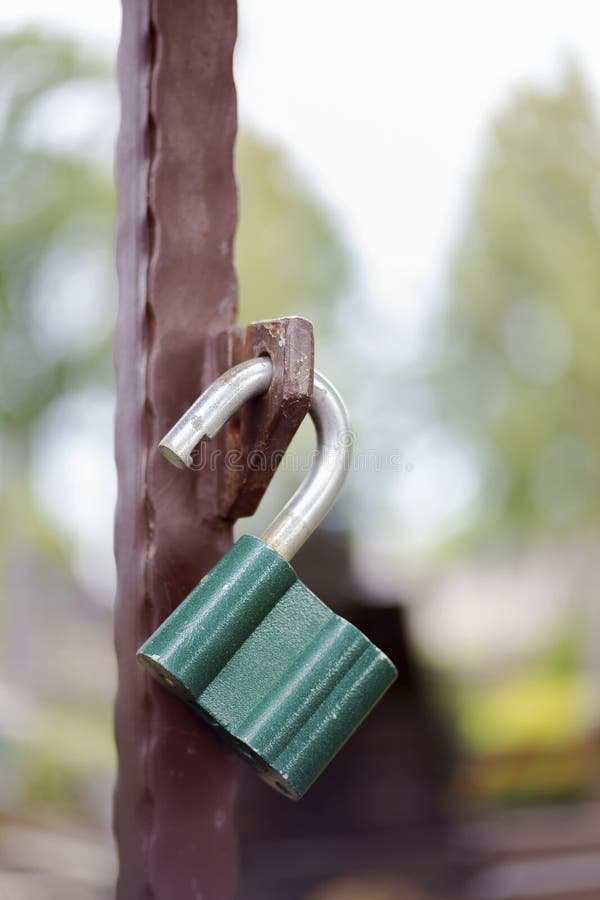 Green lock on a metal gate stock image. Image of gateway - 74214683