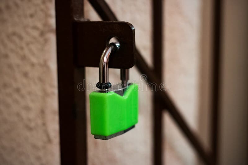 Green Lock on a Metal Grill Close Up Stock Image - Image of grille ...