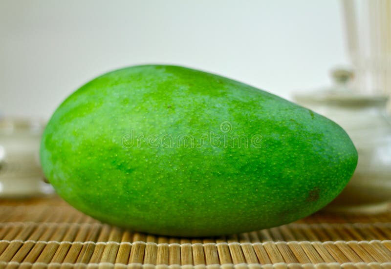 A Green Mango on Bamboo Mat Surface Stock Image - Image of city ...