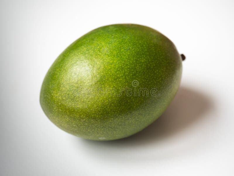 One Green Mango Closeup on a White Background Stock Photo - Image of ...