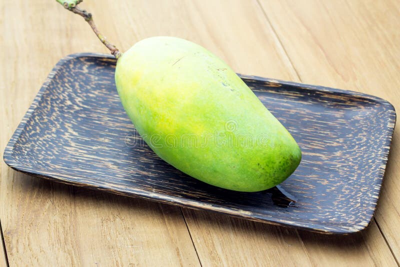 Green mango in wood plate stock photo. Image of colorful - 60224078