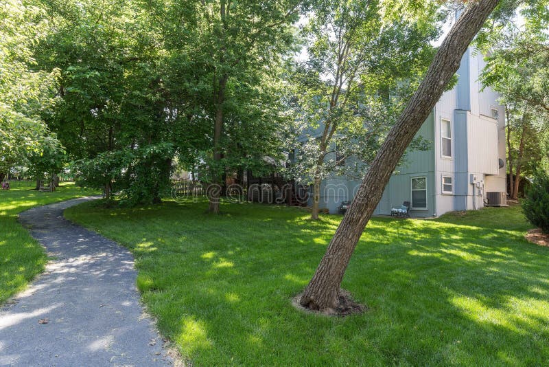 Green Manicured Lawn with Walkway and Trees in Front of the Grey ...