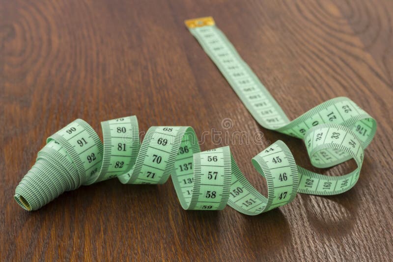 Green Measuring Tape on a Blackboard, Close-up Stock Image - Image of ...