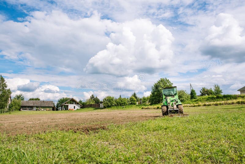 A Green Mini Skid Steer Loader Clear the Construction Site. Land Work ...