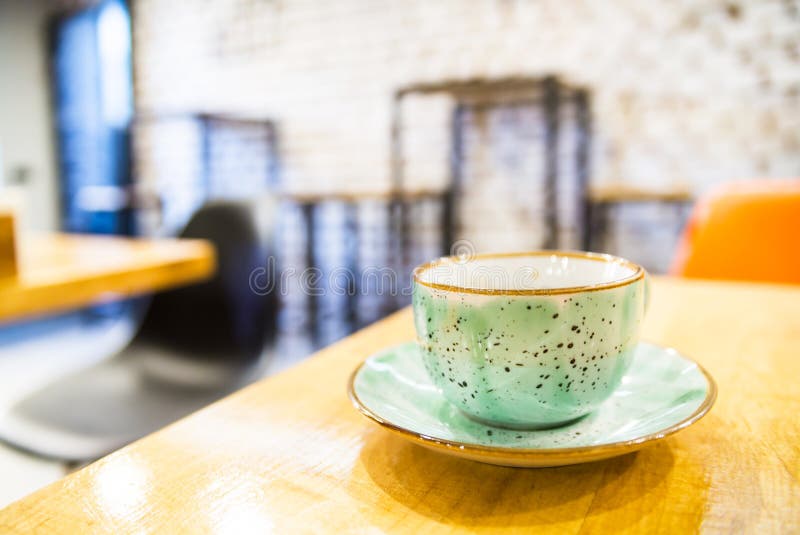 Green Modern Cup of Coffee on Table in Cafe. Perspective View of Wooden ...