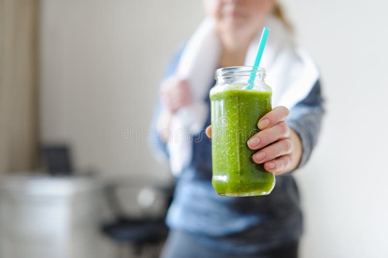 Green Monster Cocktail in Hand at the Young Woman. Stock Image - Image ...