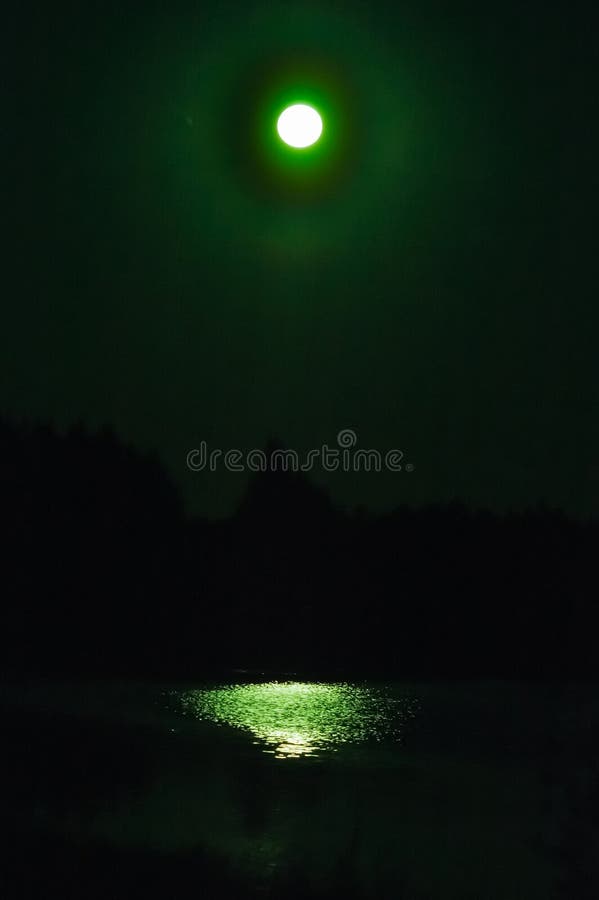 Green Moon in the Night Sky Reflected in a Lake, Finland. Stock Photo ...