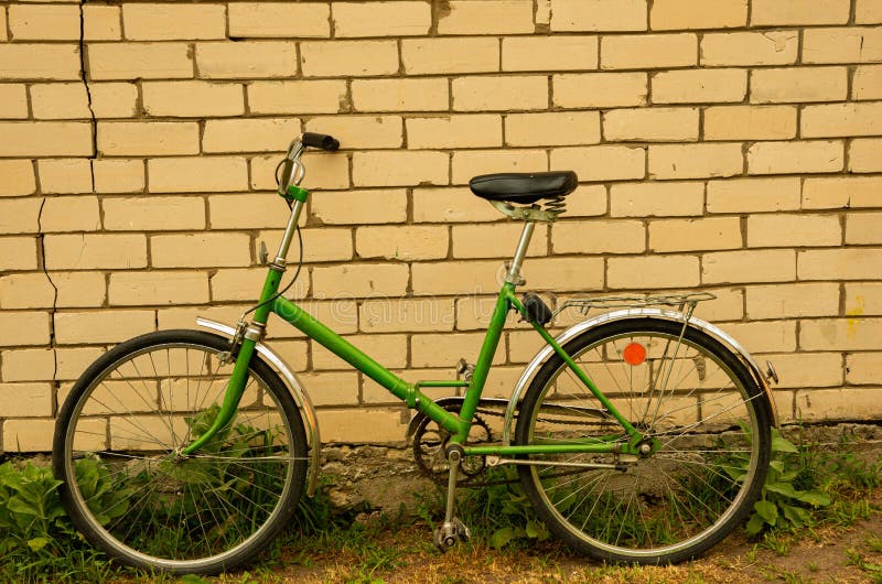 Green Old Retro Russian Folding Bicycle on a Background of White Bricks ...